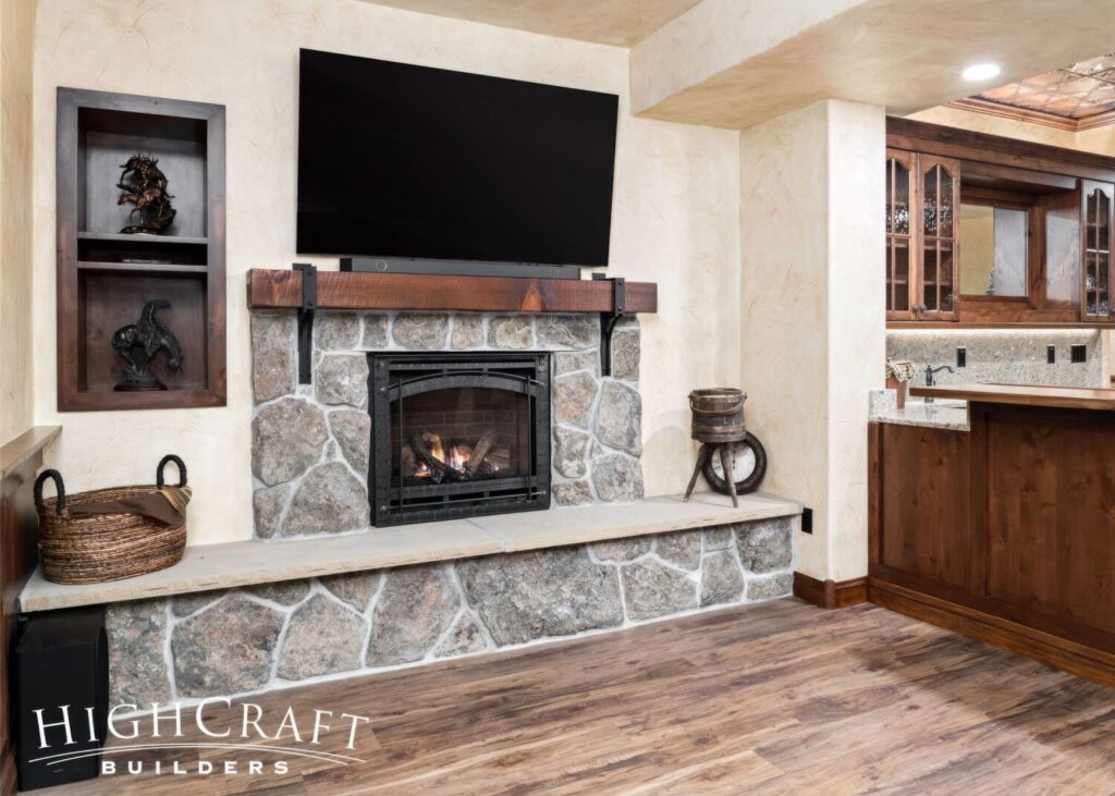 basement-remodel-stone-fireplace-tv-wood-wall-niche-detail - HighCraft